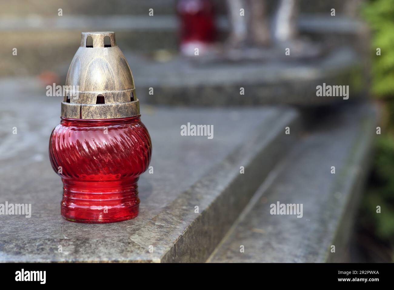 Red grave lantern with burning candle on granite surface in cemetery, space for text Stock Photo ...