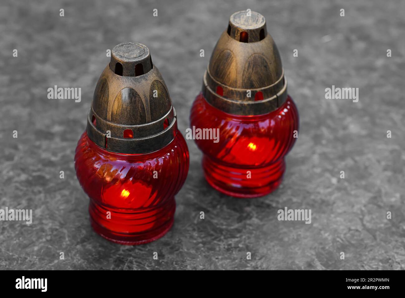 Red grave lanterns with burning candles on granite surface Stock Photo - Alamy