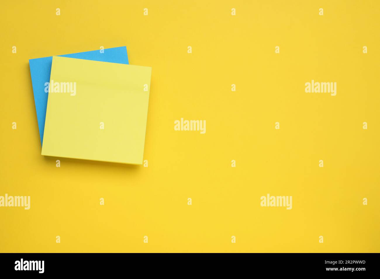 Paper notes on yellow background, top view. Space for text Stock Photo ...