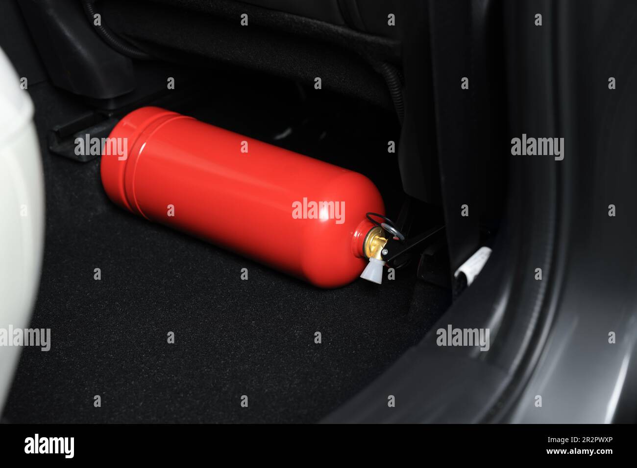Red fire extinguisher in trunk. Car safety equipment Stock Photo - Alamy