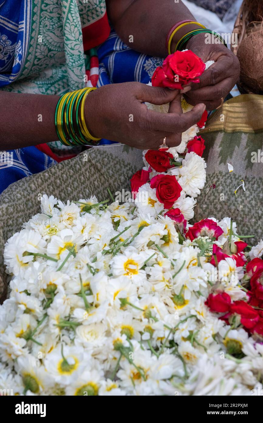 woman making garland of flowers Stock Photo - Alamy