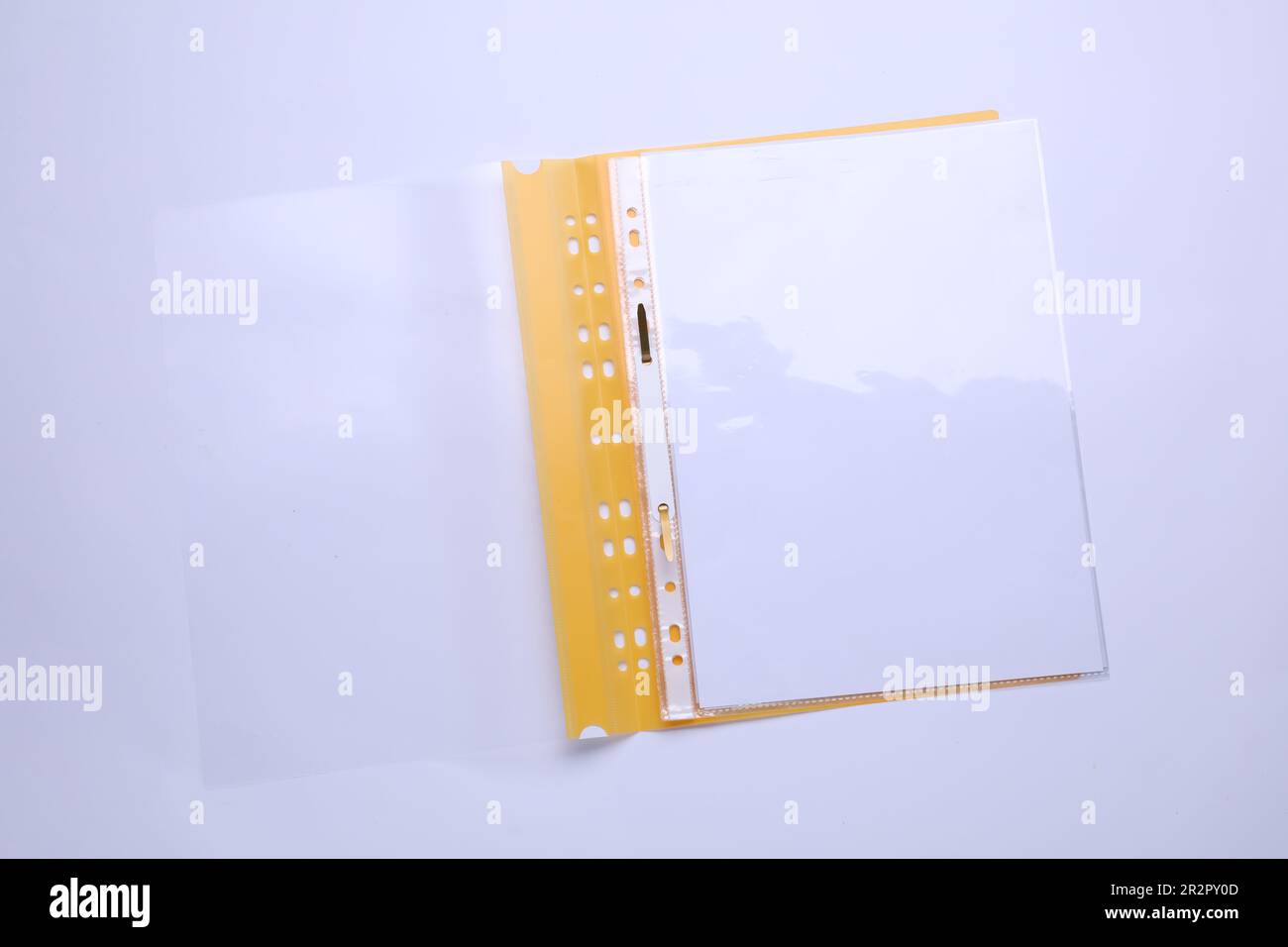 File folder with punched pockets and paper sheets isolated on white ...