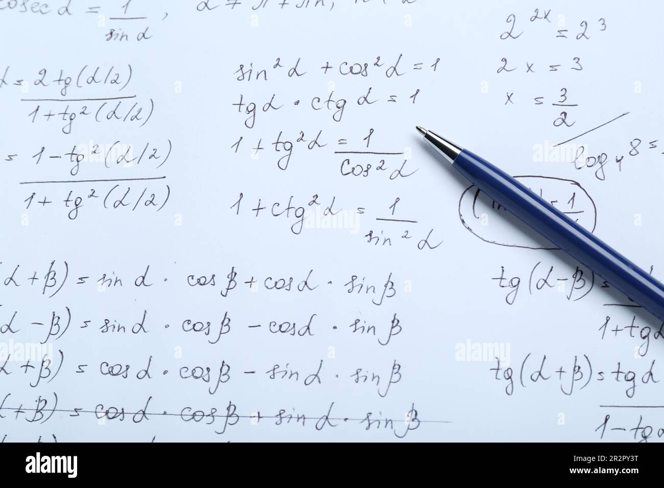 Sheet of paper with different mathematical formulas and pen, top view ...