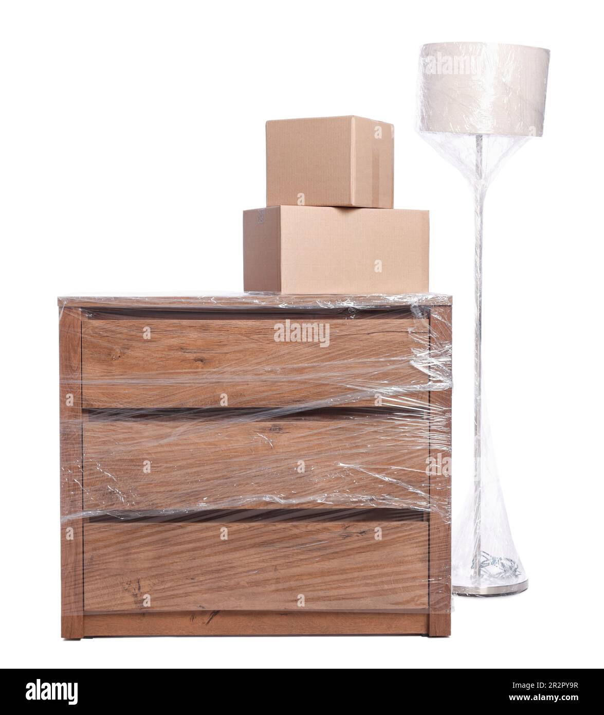 Boxes, lamp and chest of drawers wrapped in stretch film on white ...