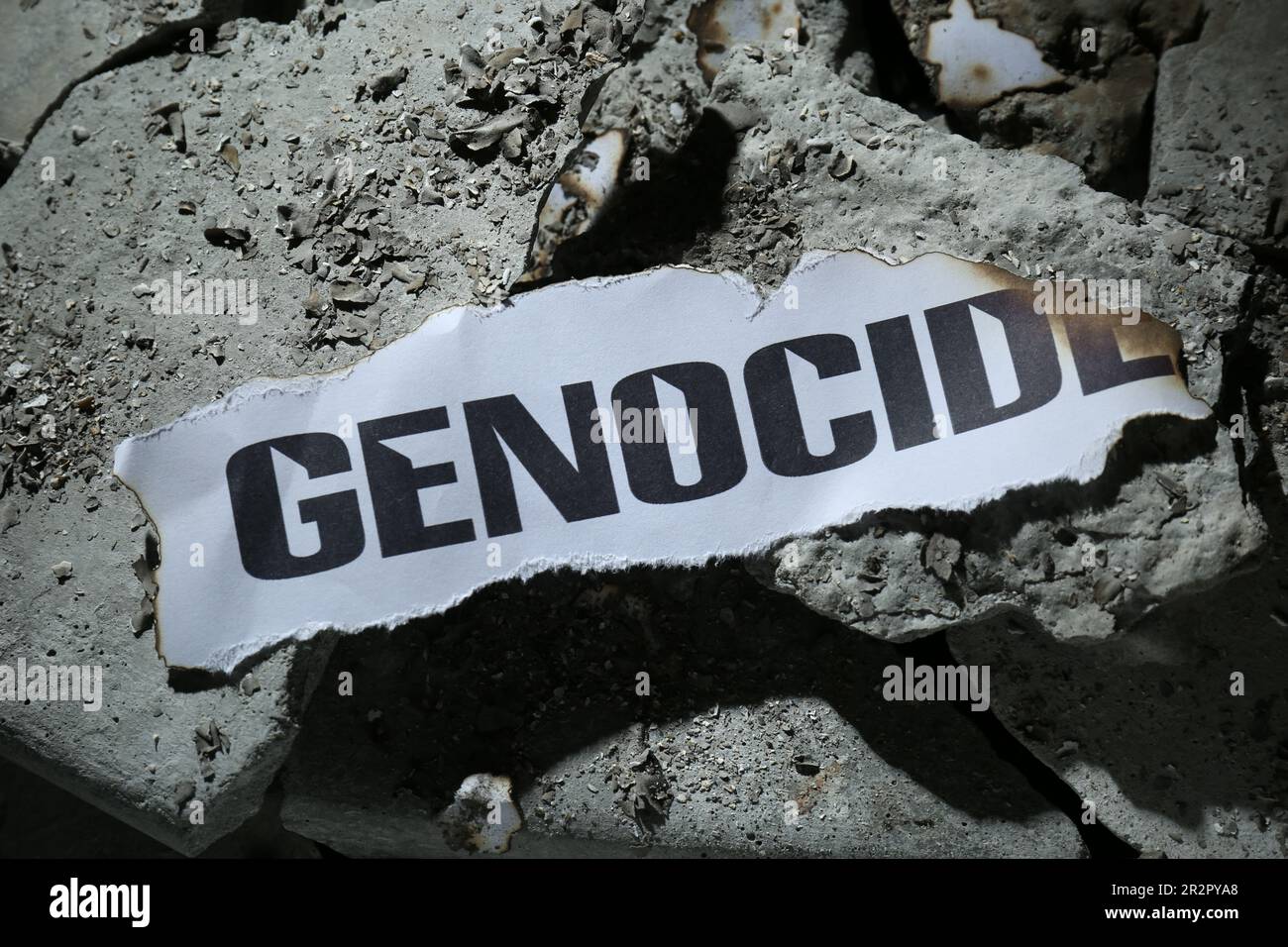 Paper with word Genocide on pieces of concrete, top view Stock Photo ...