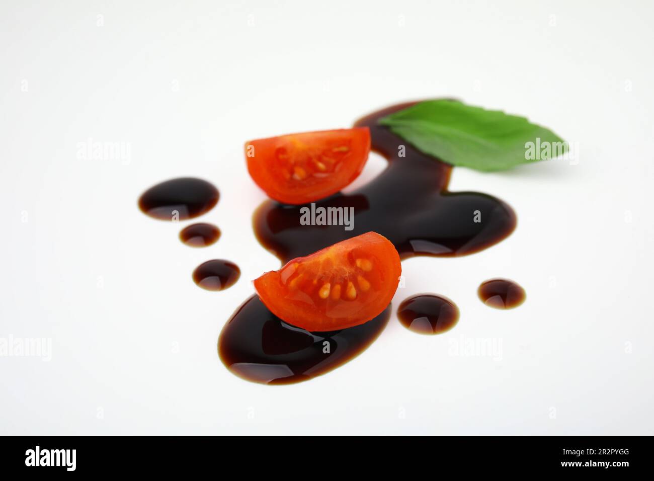 Tomatoes, basil leaf and balsamic vinegar on white background Stock ...