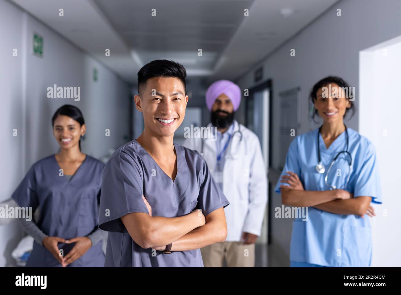Group portrait of happy diverse male and female doctors standing in ...