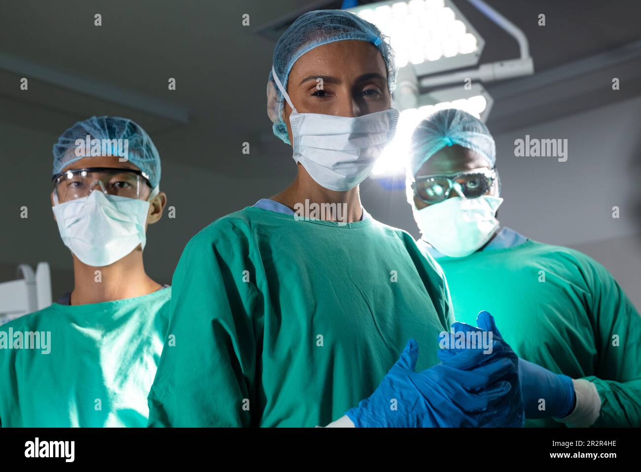 Portrait of biracial female surgeon and diverse male colleagues in ...