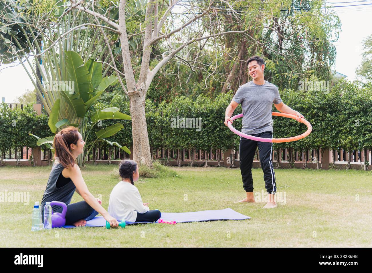 mother and child daughter practicing doing yoga exercises outdoors ...