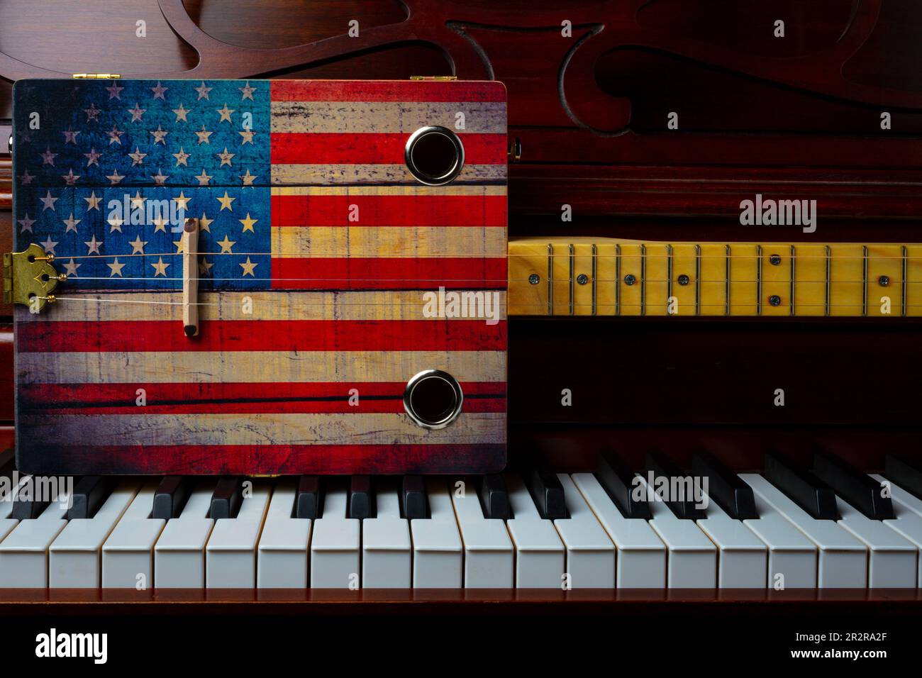Cigar Box American Flag Guitar On Piano Keys Still Life Stock Photo - Alamy