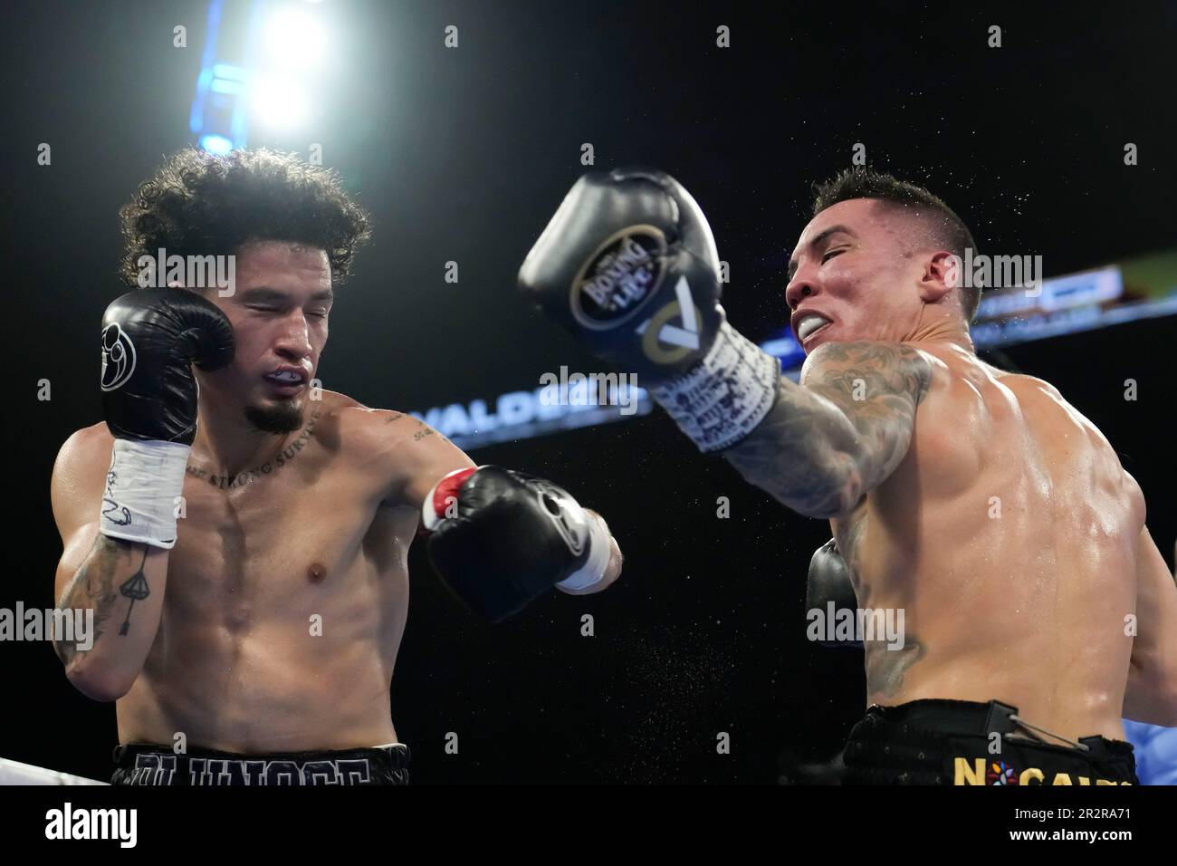 Adam Lopez, left, fights Oscar Valdez in a junior lightweight boxing ...