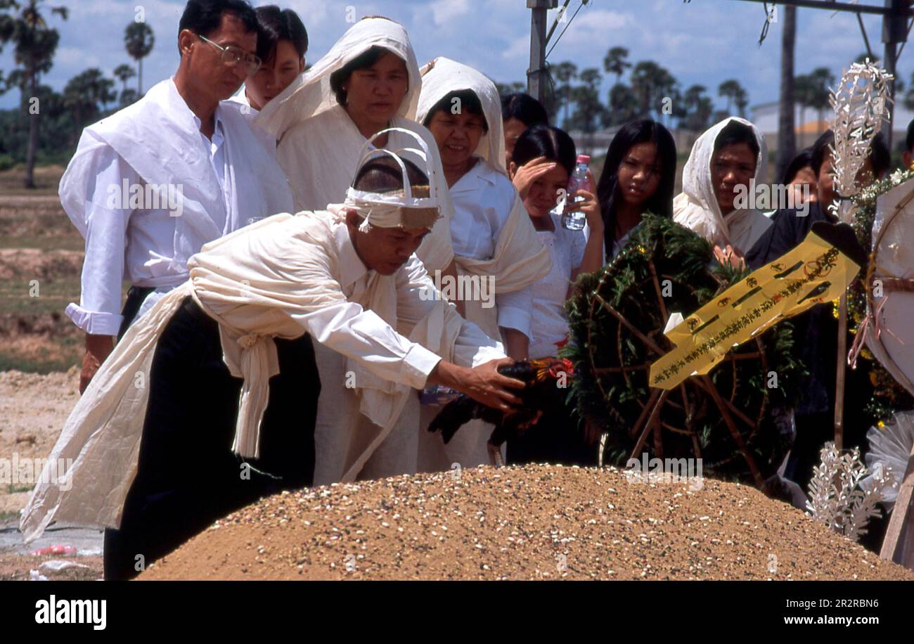Placing a chicken on the grave of an ancestor Cambodia Stock Photo - Alamy