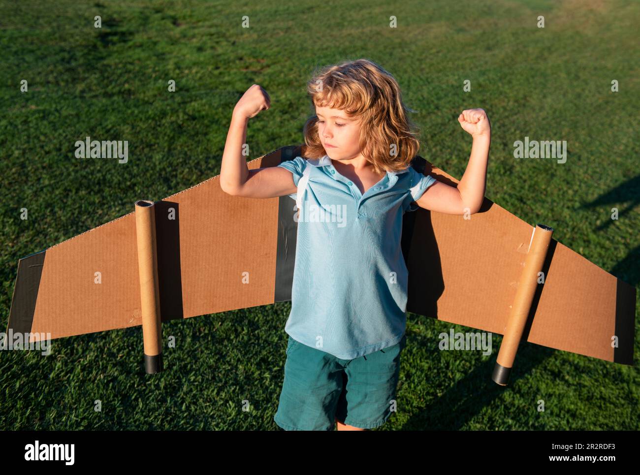 Superhero child shows muscles. Strong kid. Success, motivation concept ...