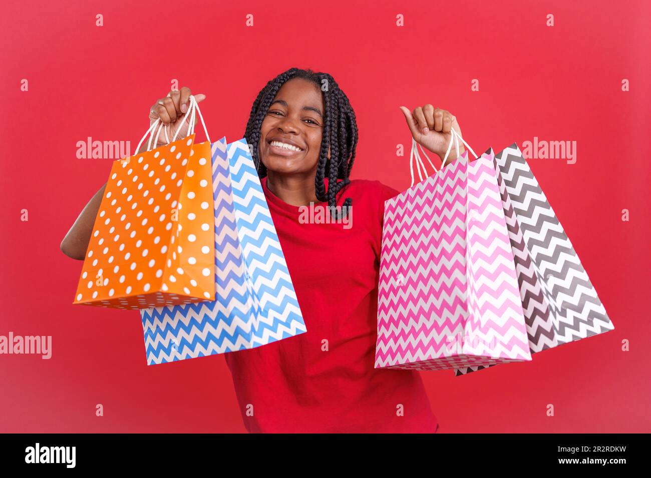 African woman raising many shopping hi-res stock photography and images ...
