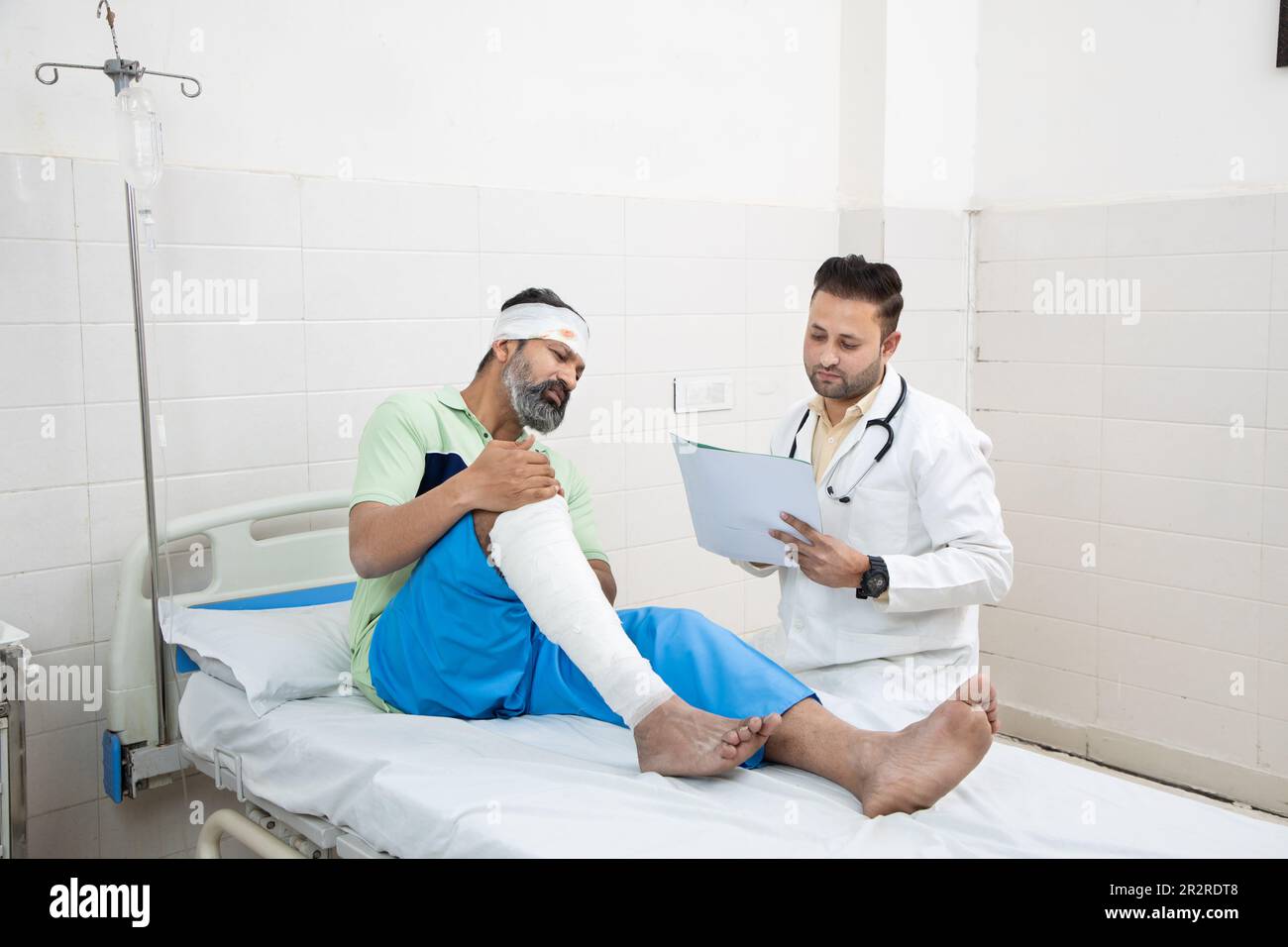Indian patient with bone fracture listening to, Young injured man with ...