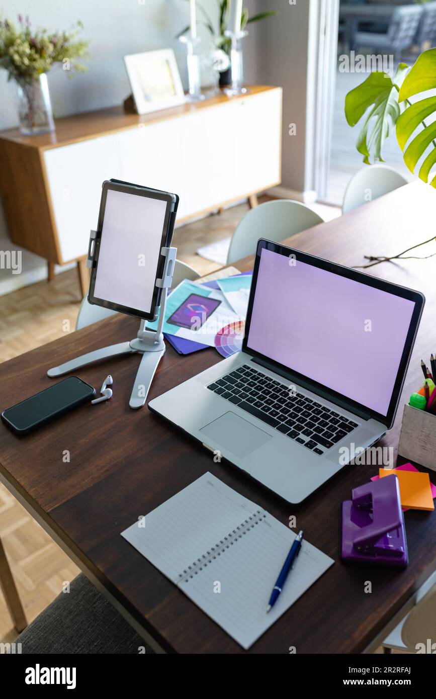 Notepad and smartphone with laptop and tablet with copy space on ...