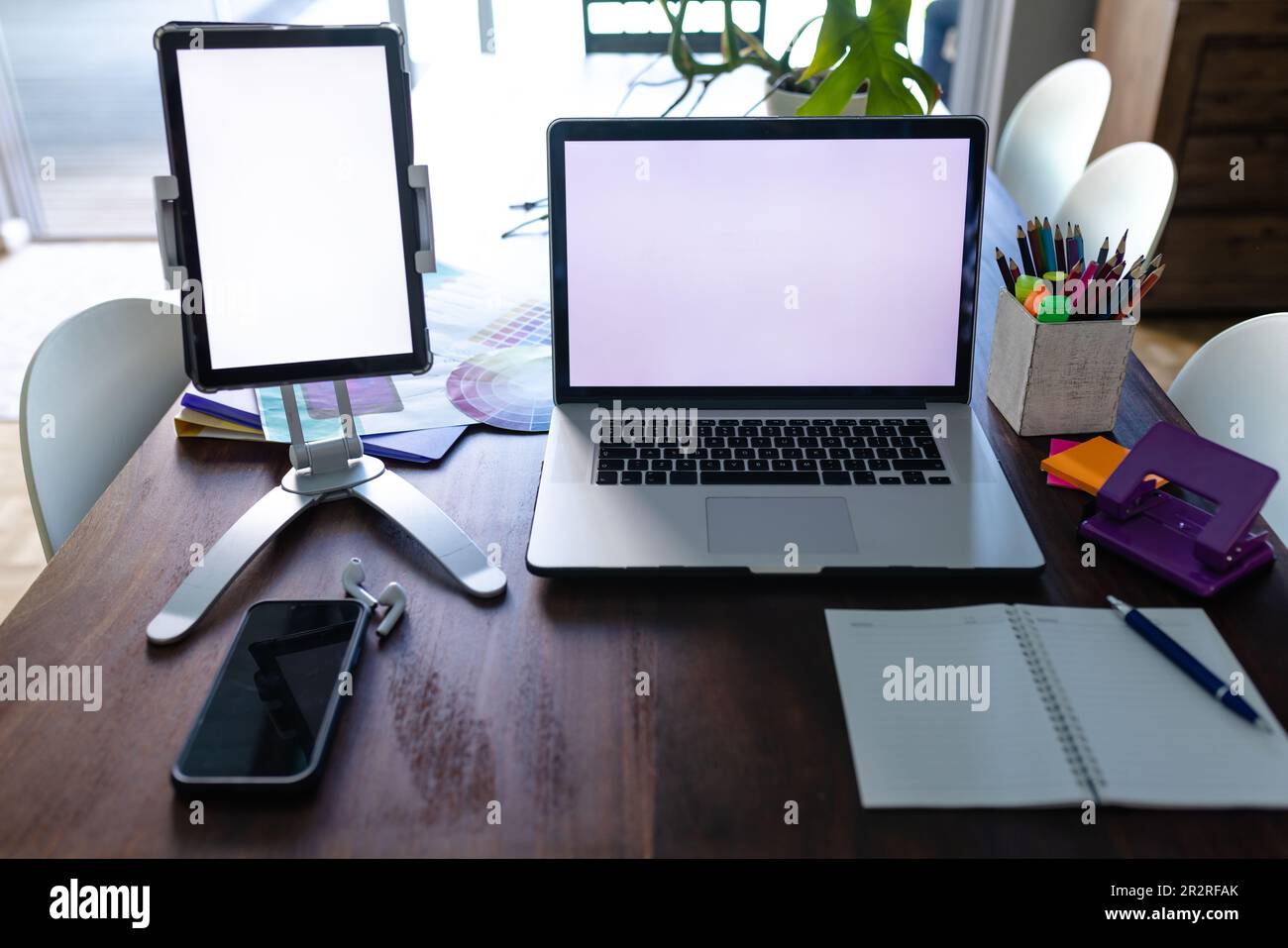 Notepad and smartphone with laptop and tablet with copy space on ...