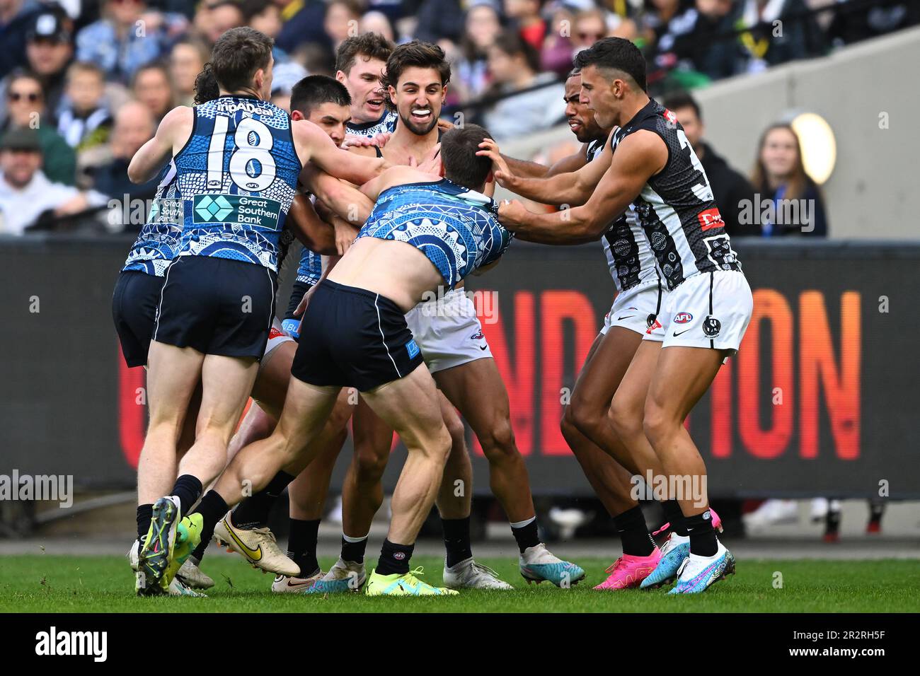 Josh Daicos of Collingwood (centre) scuffles with Matthew Owies of ...