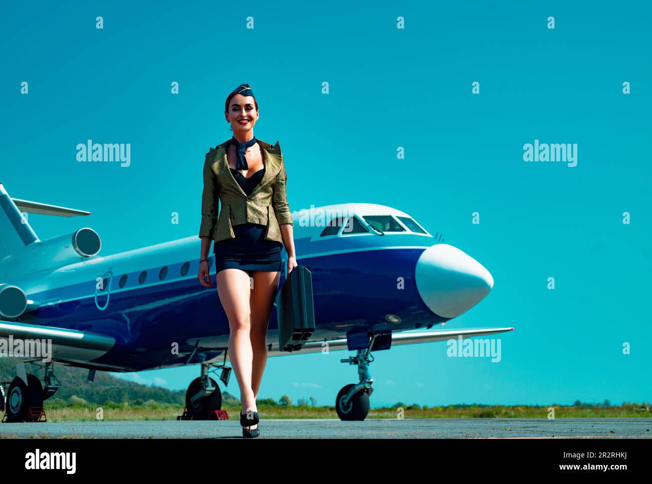 Full length of airhostess on private jet airplane on airport. Airline ...