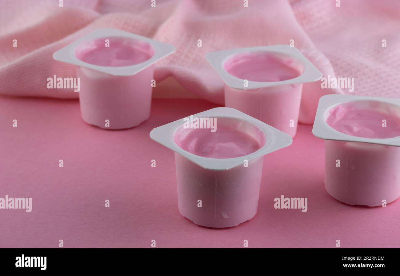 Pink yogurt, strawberry flavored yogurt isolated on pink background ...
