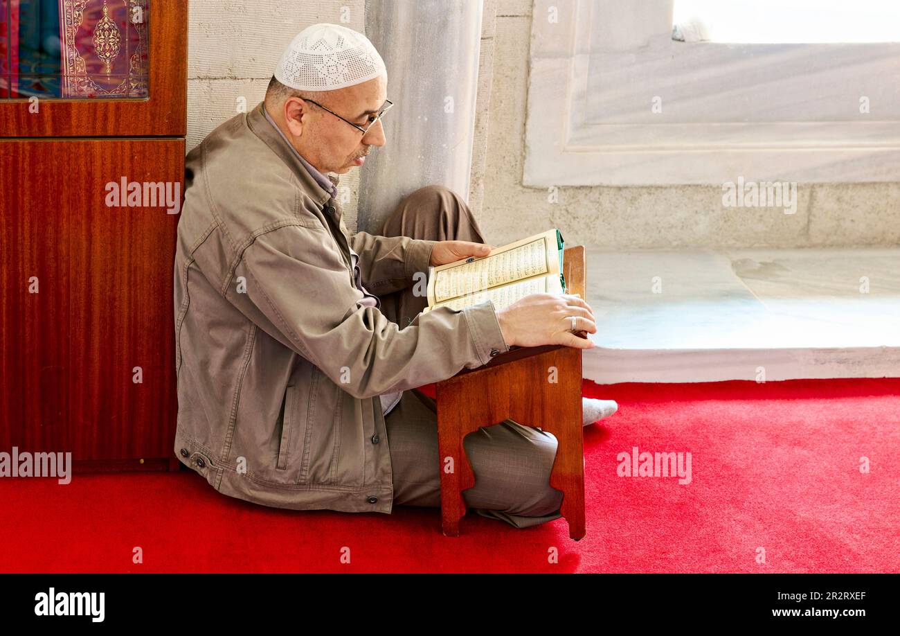 Istanbul Turkey. Muslim believer praying and reading Koran in the Fatih ...