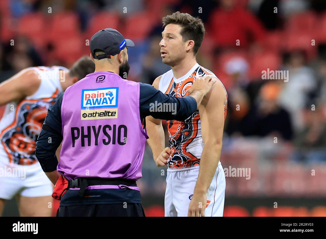 Toby Greene of the Giants has his shoulder checked by a physio during ...