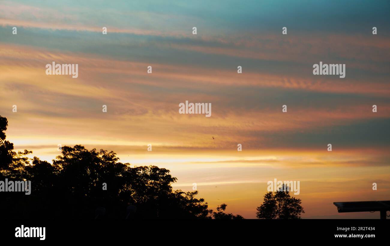 Sunset with wispy clouds painting Stock Photo - Alamy