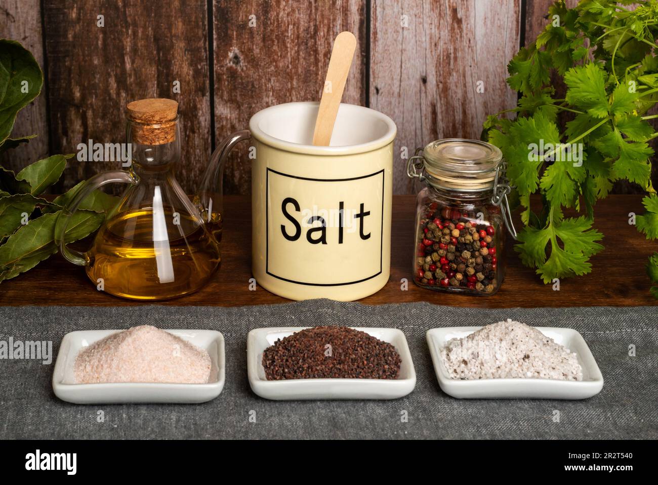 Salt jar together with small dishes with different types of salt, black ...