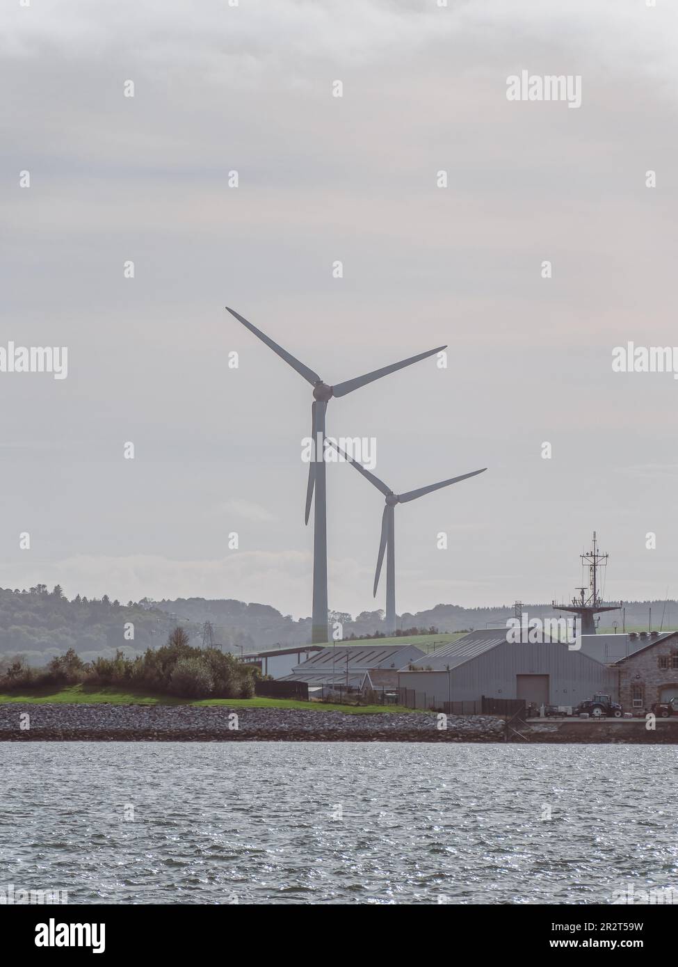 Wind power generators in the Ireland, landscape. Two wind turbines ...
