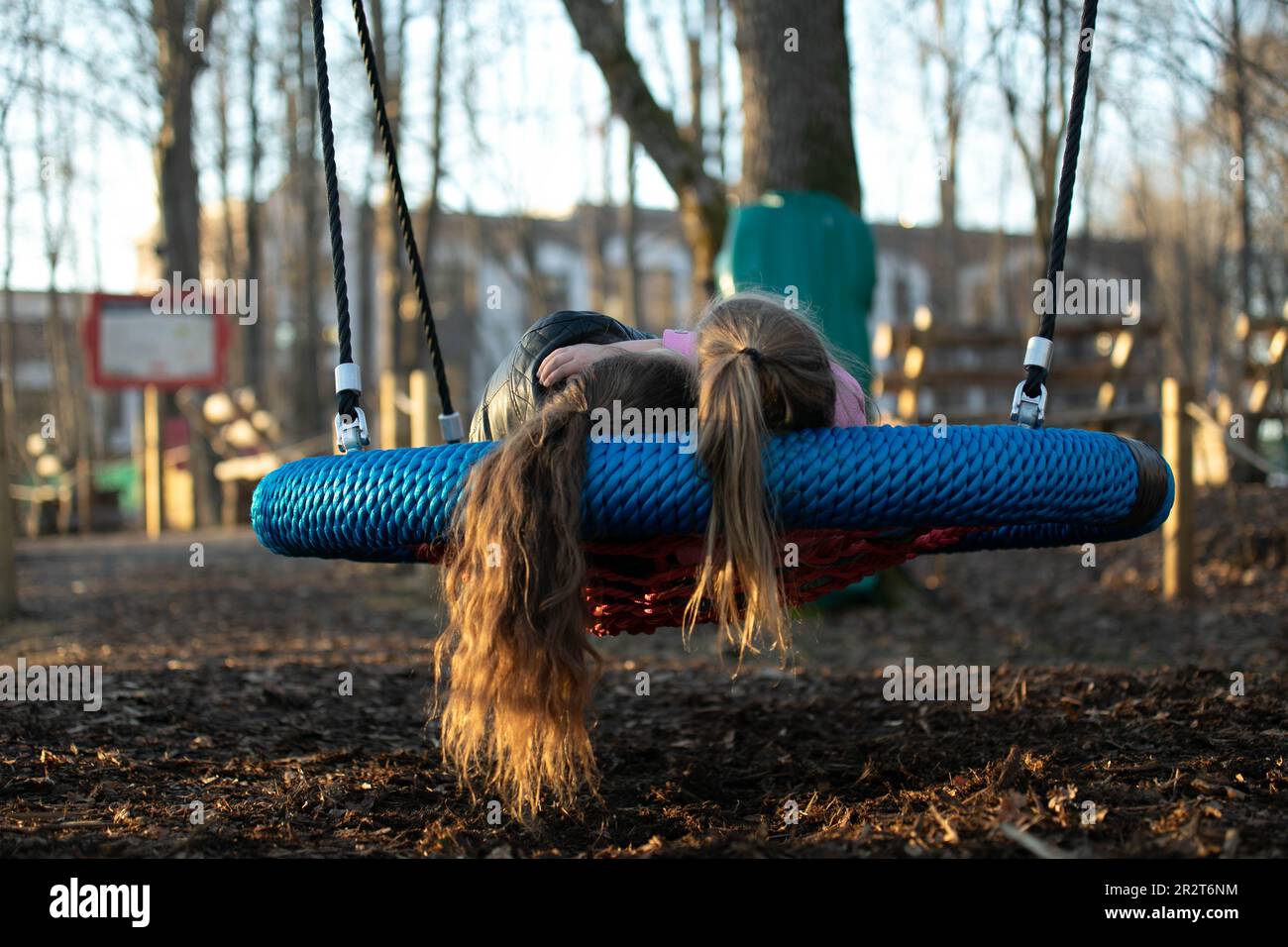 2 girls swinging on a swing Stock Photo - Alamy