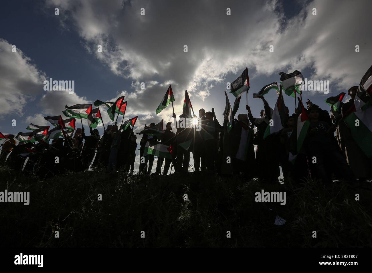 Gaza, Palestine. 18th May, 2023. Palestinians wave national flags ...