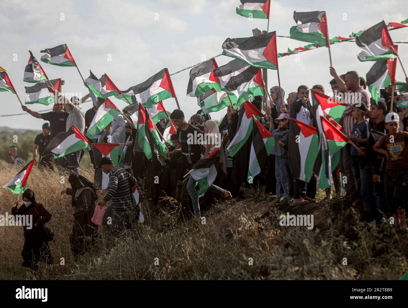 Gaza, Palestine. 18th May, 2023. Palestinians wave national flags ...