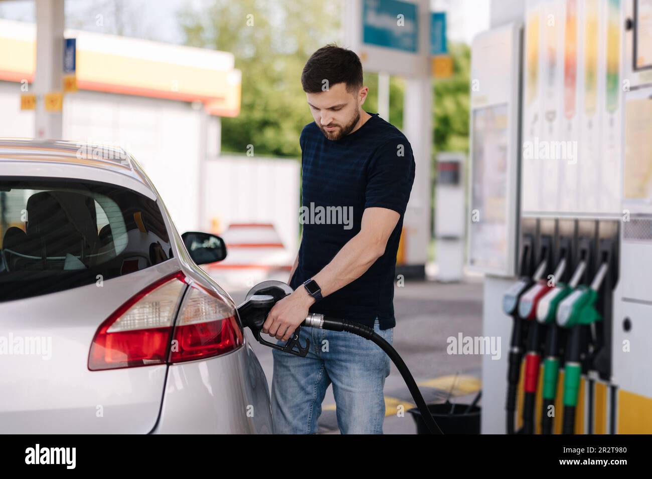 Handsome man using gasoline nozzle hi-res stock photography and images ...