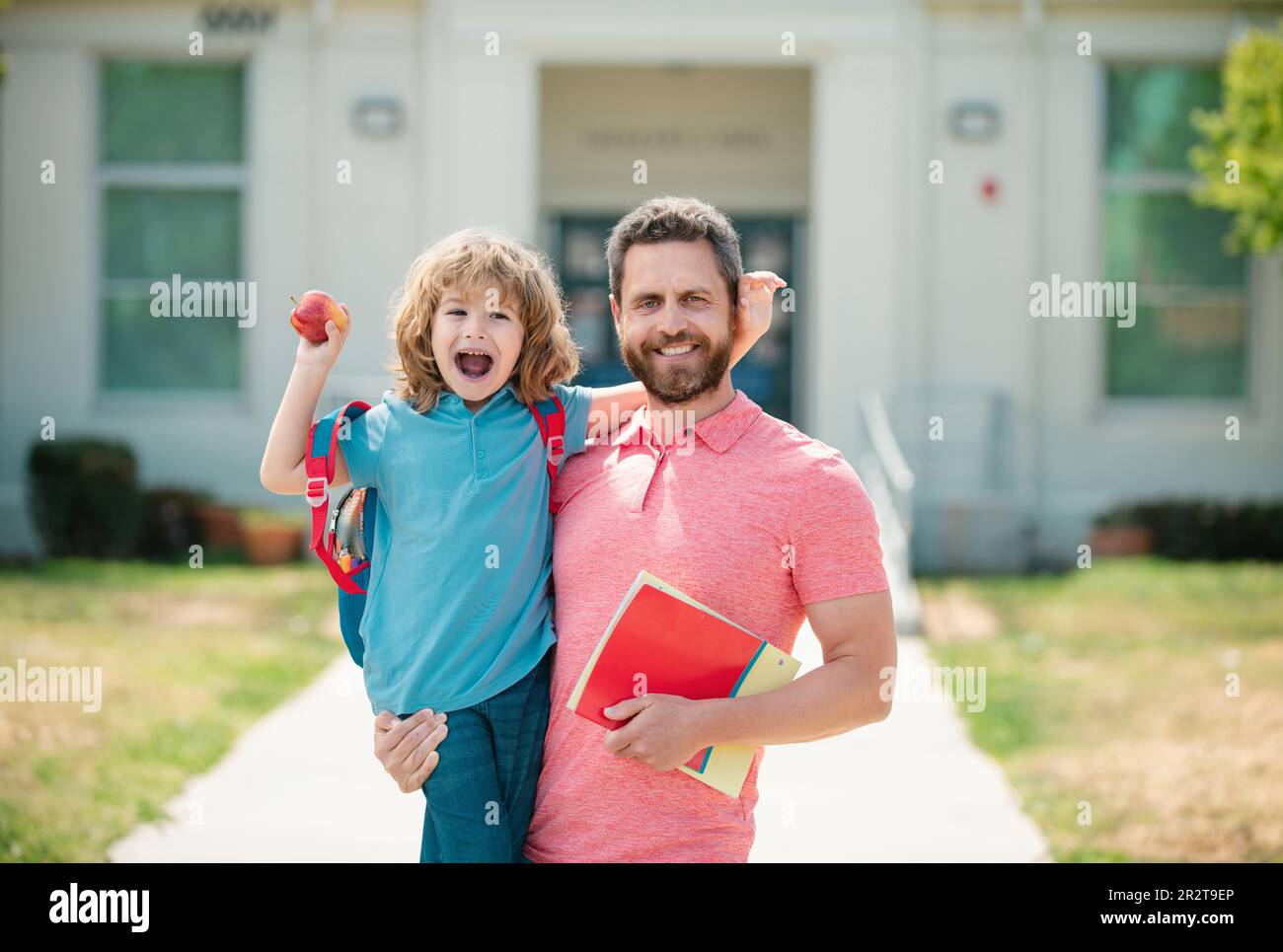 Portrait of teacher and happy pupil. Father supports and motivates son ...