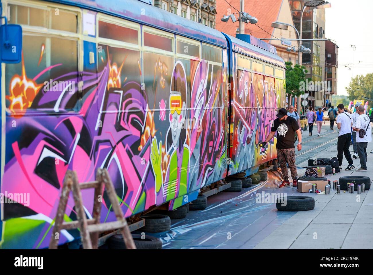 Osijek, Croatia. 20th May, 2023. Artist paints graffiti on a tram during the Oscans, festival of ...