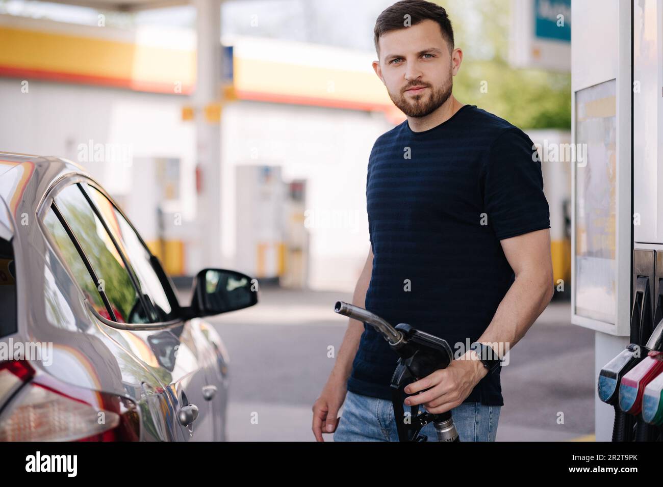 Handsome man using gasoline nozzle hi-res stock photography and images ...