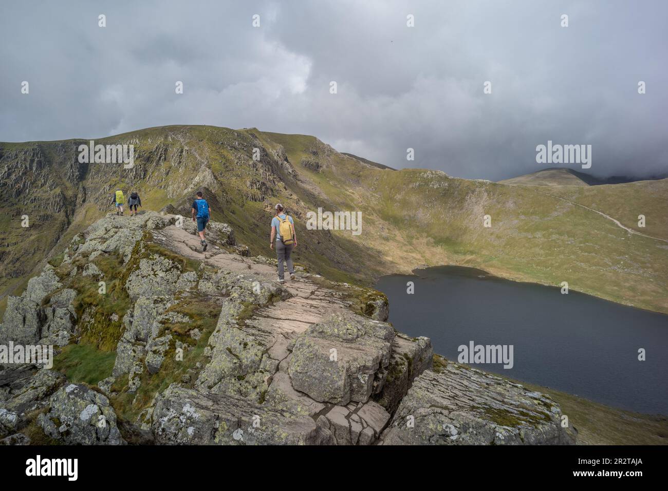 walkers on Striding Edge path with Helvellyn summit behind Stock Photo ...