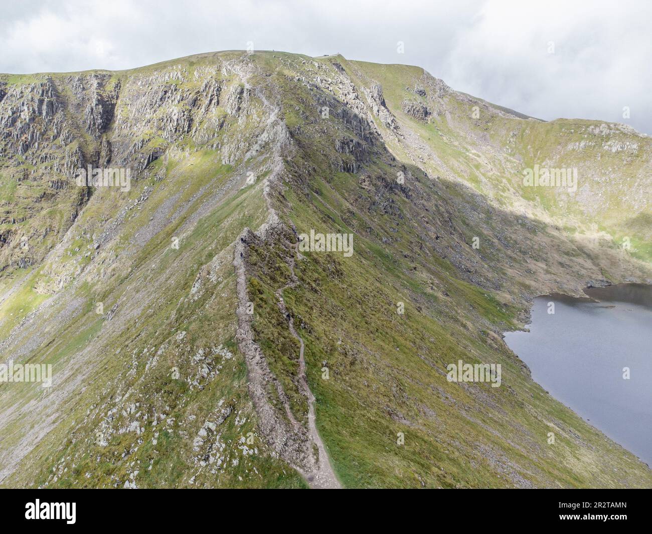 walkers on Striding Edge path with Helvellyn summit behind Stock Photo ...