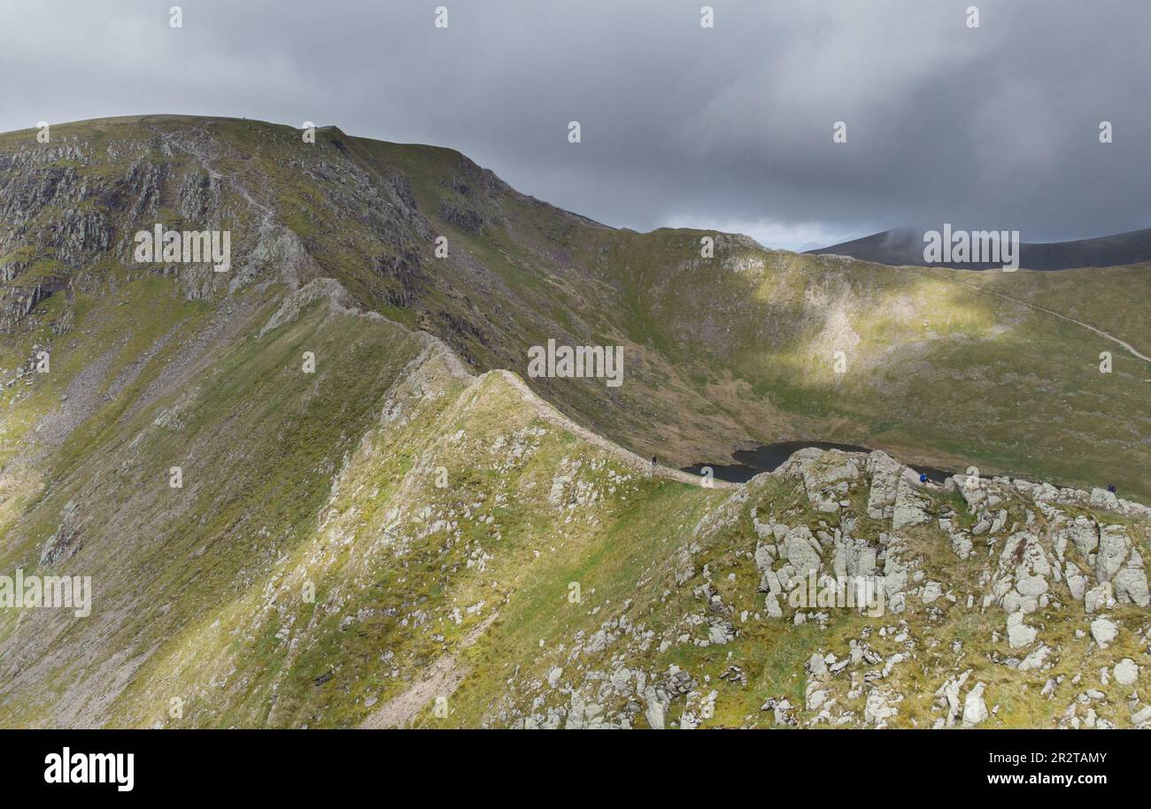 walkers on Striding Edge path with Helvellyn summit behind Stock Photo ...