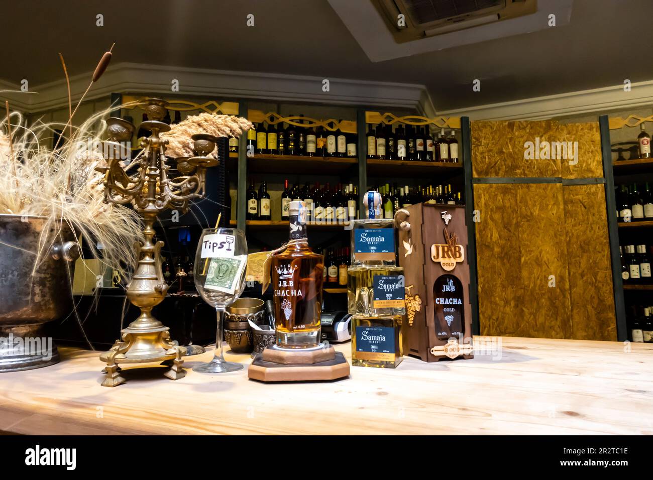 J.B.B. Chacha gold bottles on a bar desk. Tips glass, museum of Georgia ...