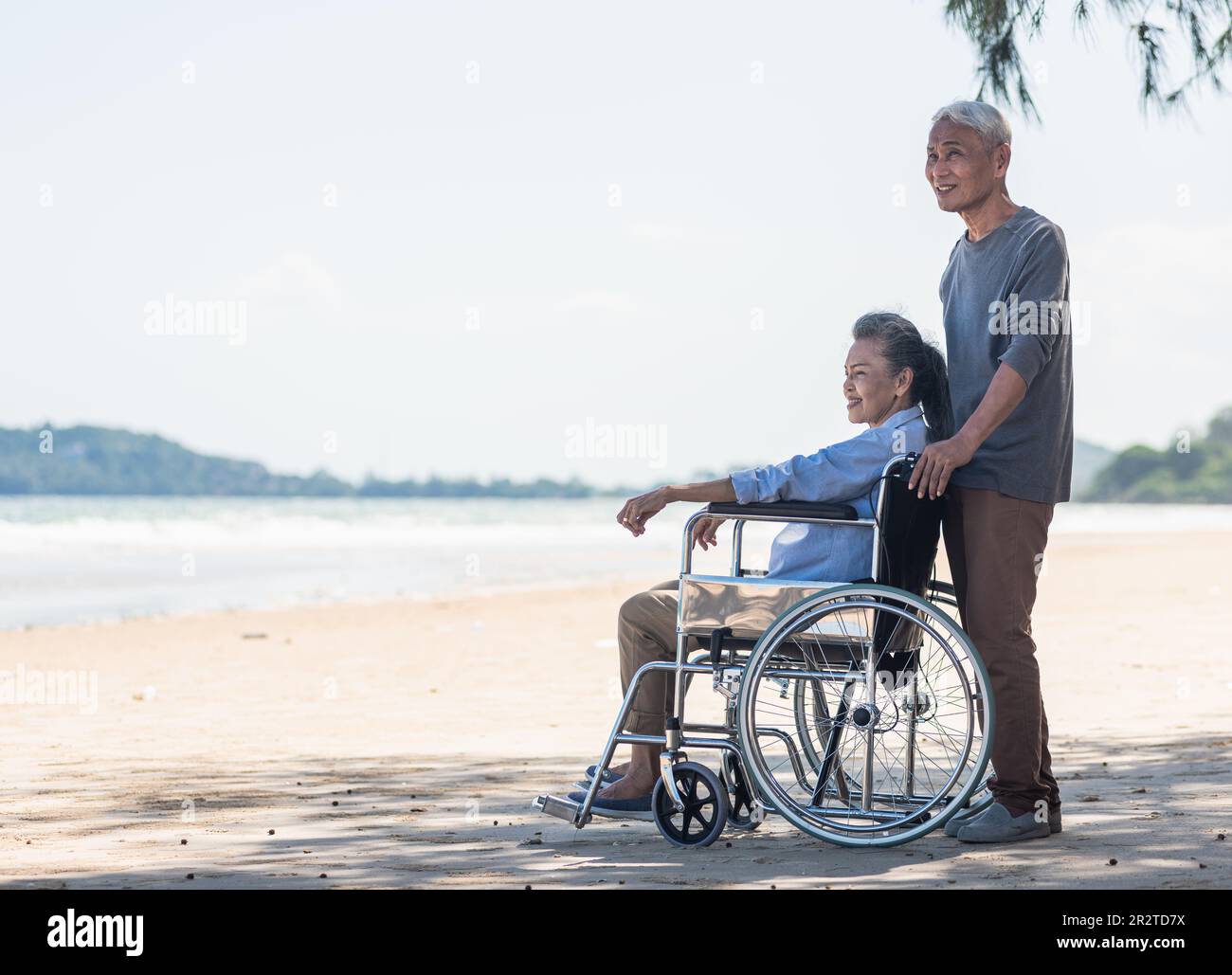 back elderly woman disabled sitting in wheelchair and husband is a ...