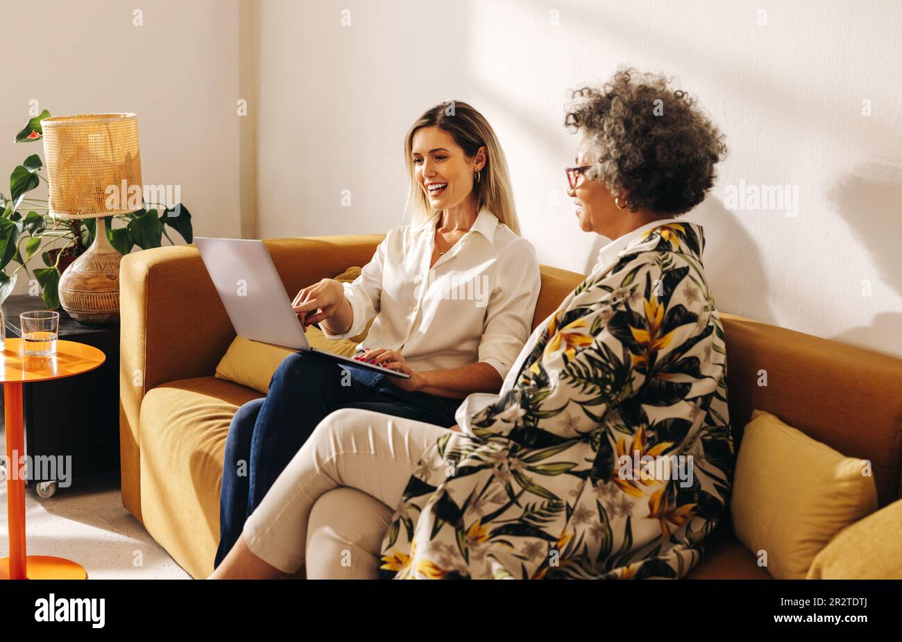 Creative businesswomen using a laptop while working together in an ...