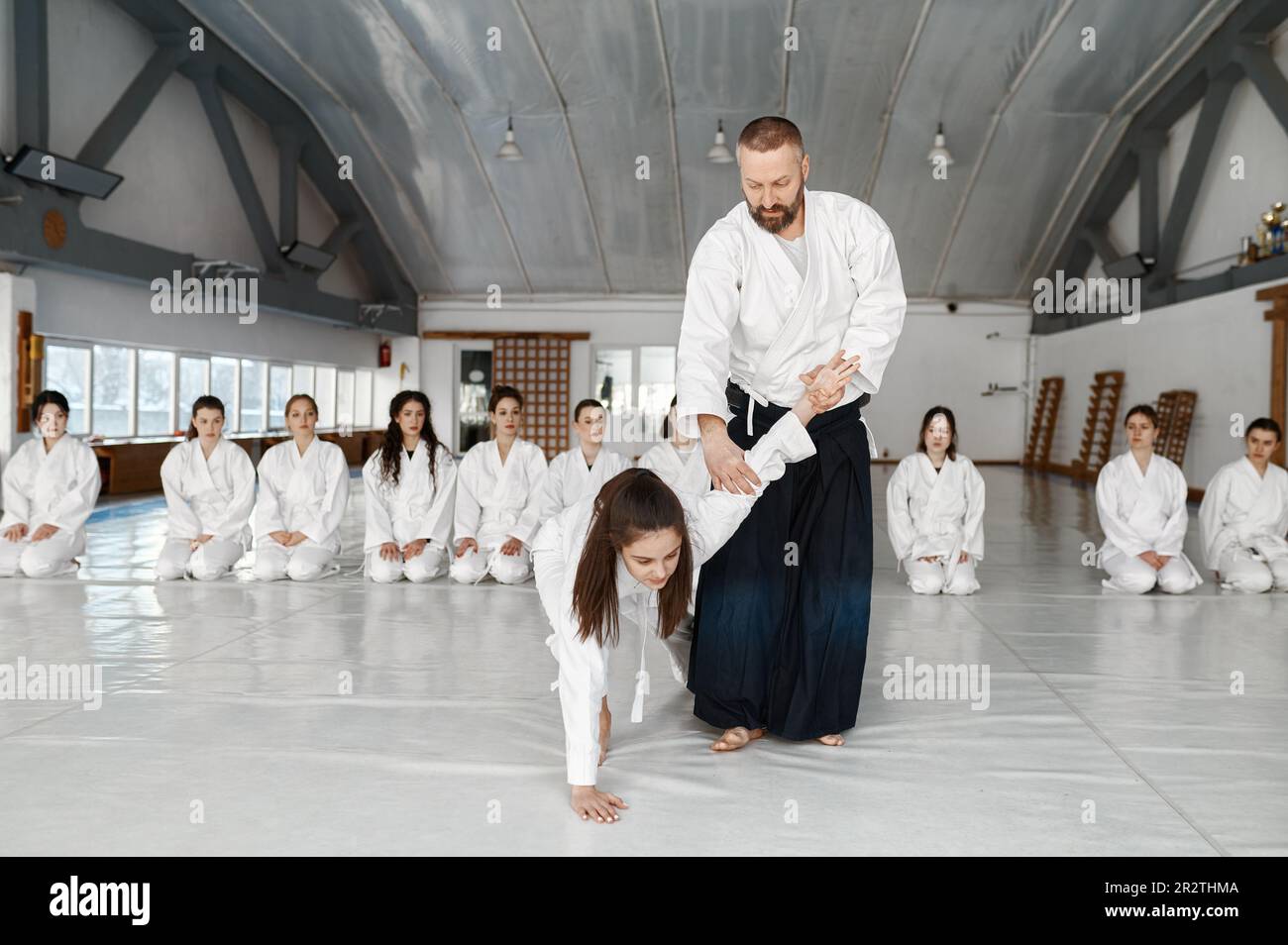 Aikido instructor teaching teenager fighters during group training in ...