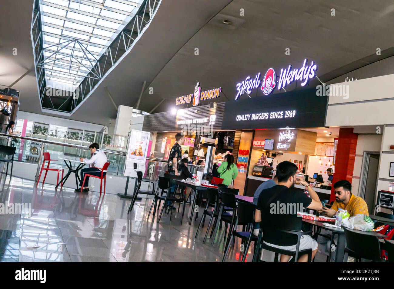 Cafe, passengers travelers in a waiting area in Tbilisi International ...