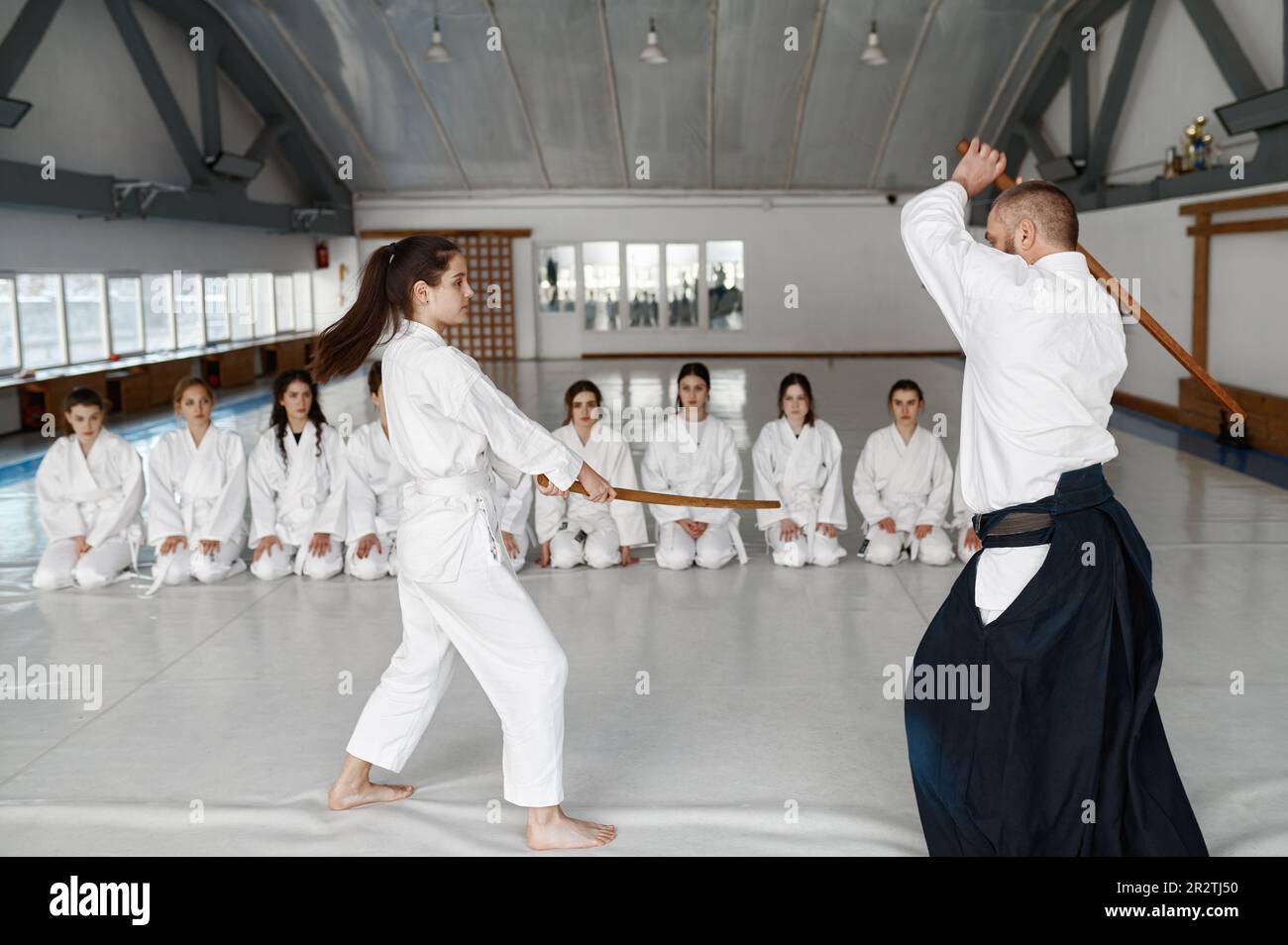 Kendo master and sudent fighting with wooden sword during martial arts ...