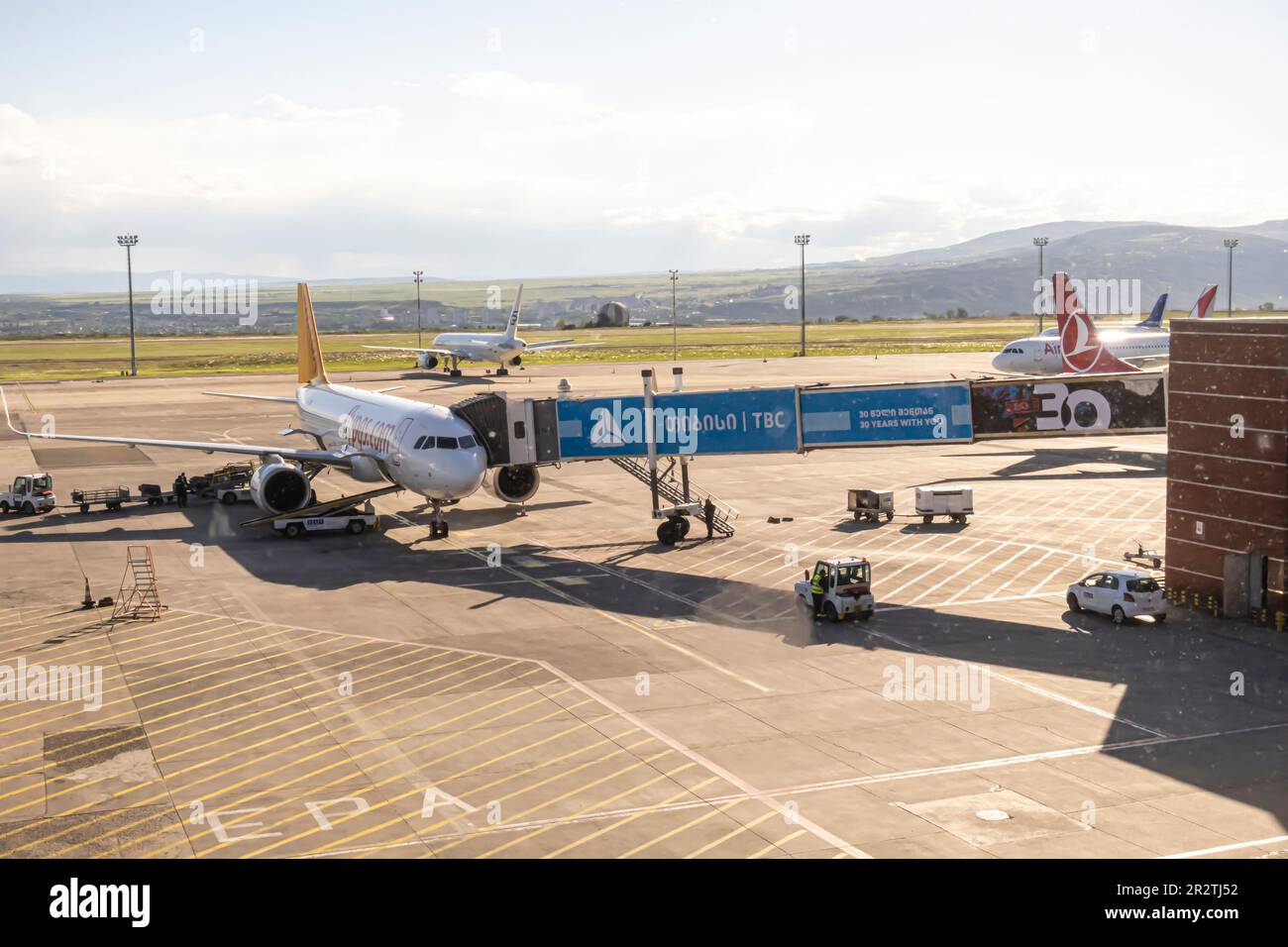 FlyPGS, Pegasus airlines plane connected to corridor to Tbilisi ...