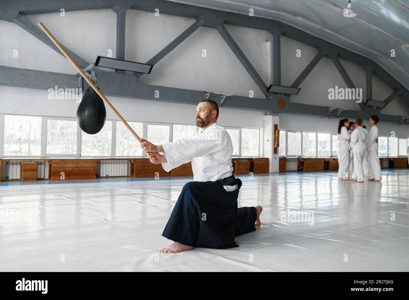 Confident and strong mature aikido master training with bokken Japanese sword Stock Photo - Alamy
