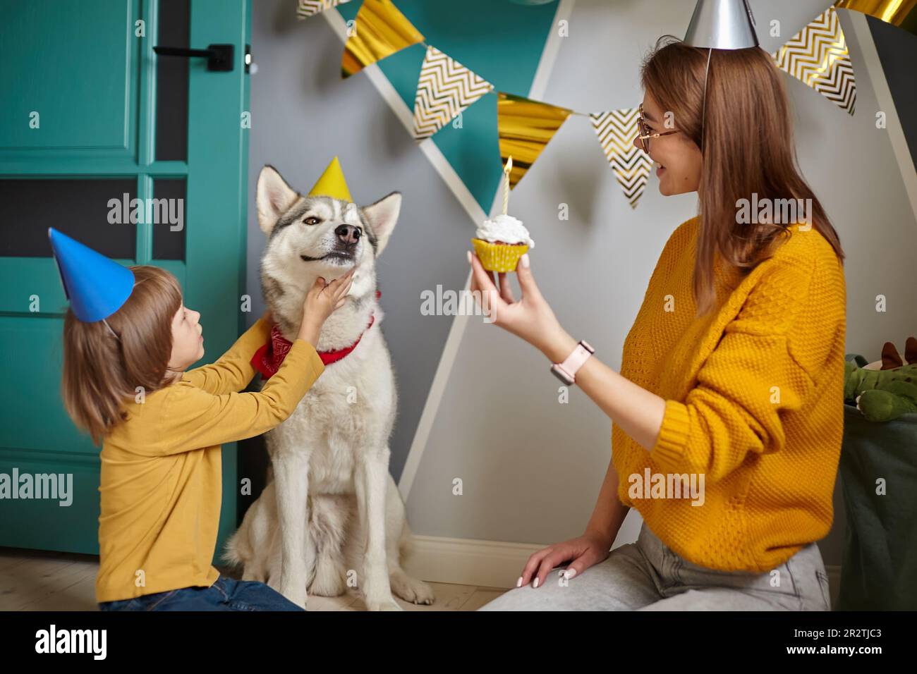 Dog pet birthday party, Happy family mother and child congratulating ...