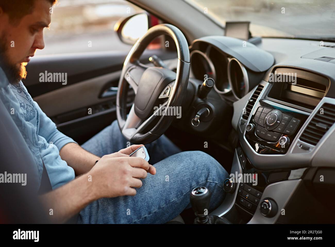 Man driver using mobile phone while sitting at the wheel of a car Stock ...