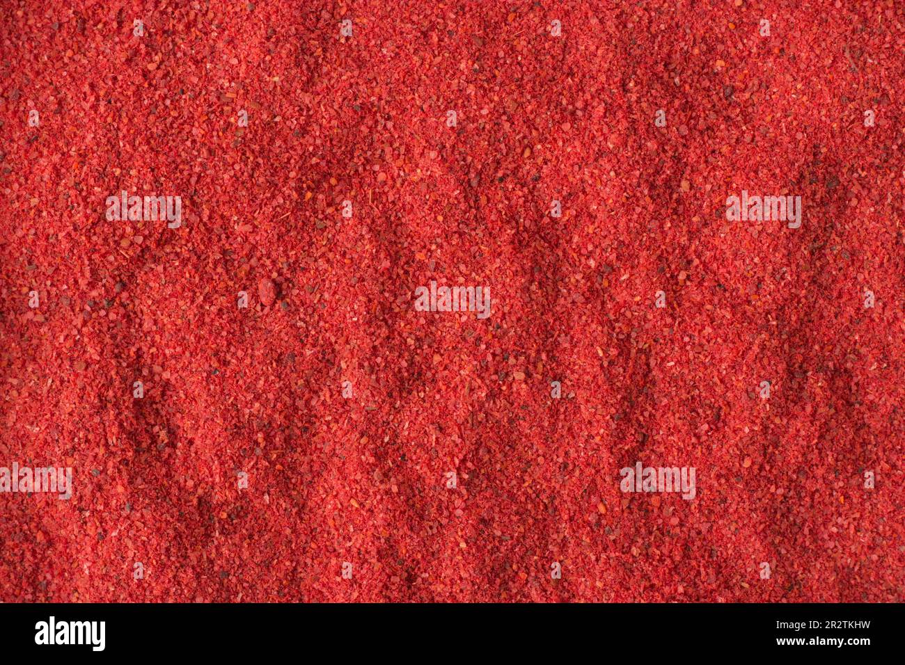 texture of hot chili pepper powder close-up, spice or seasoning as ...